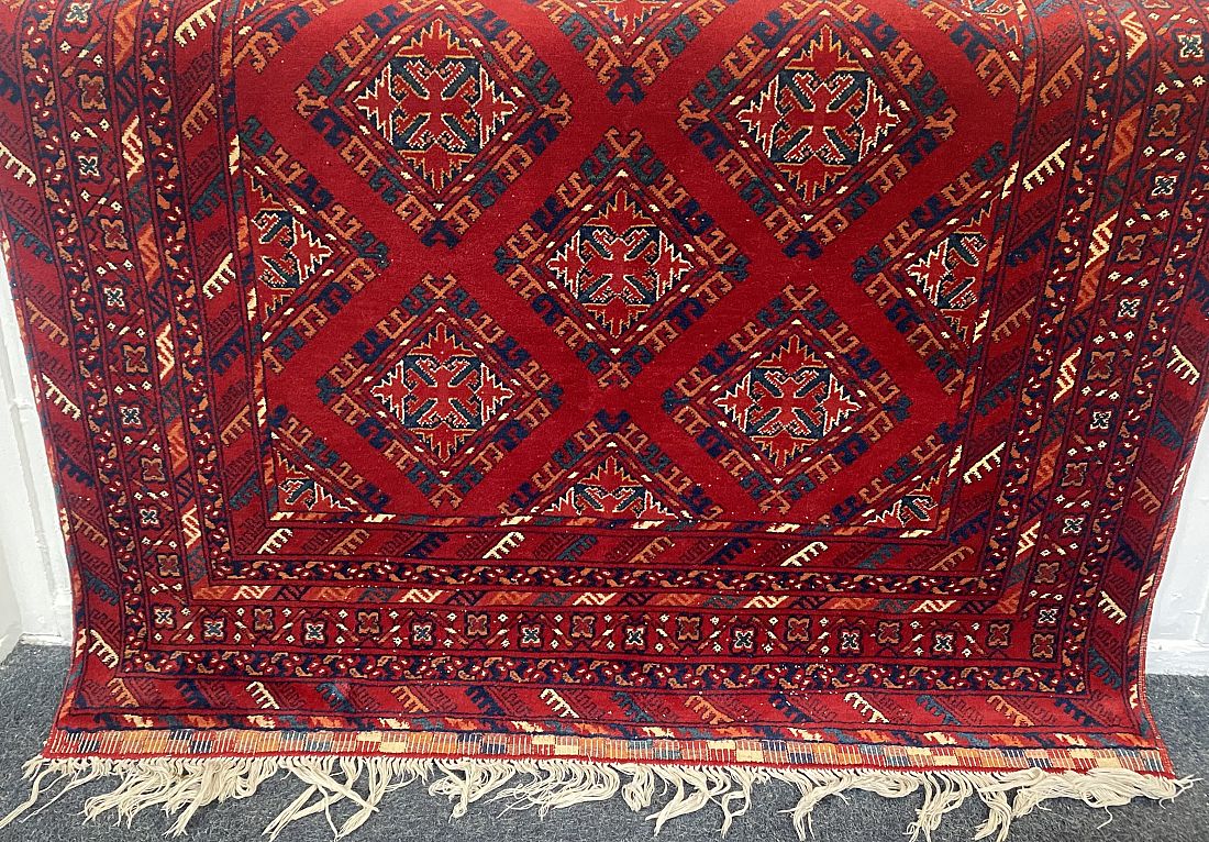 A Persian rug, red ground with... | Henry Adams Auctions